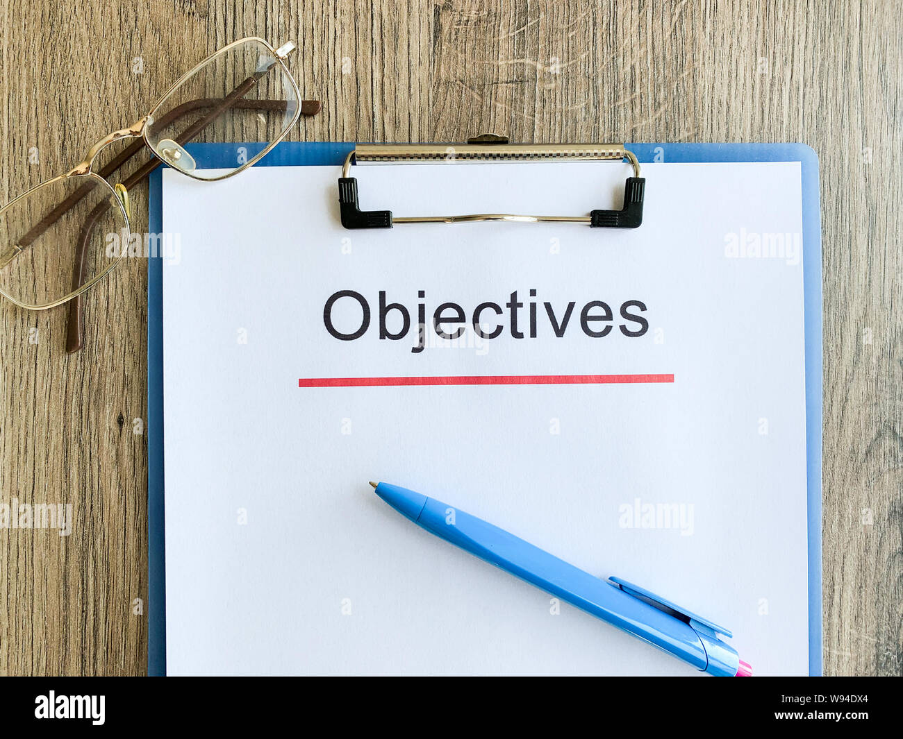 Paper with text objective on wood table Stock Photo - Alamy