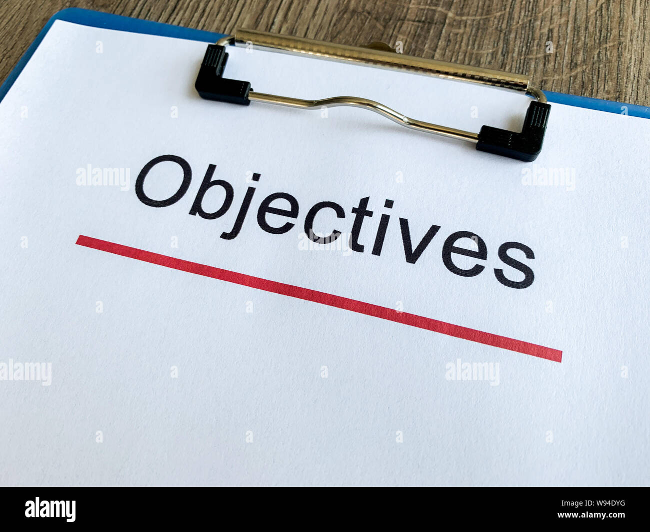 Paper with text objective on wood table Stock Photo - Alamy