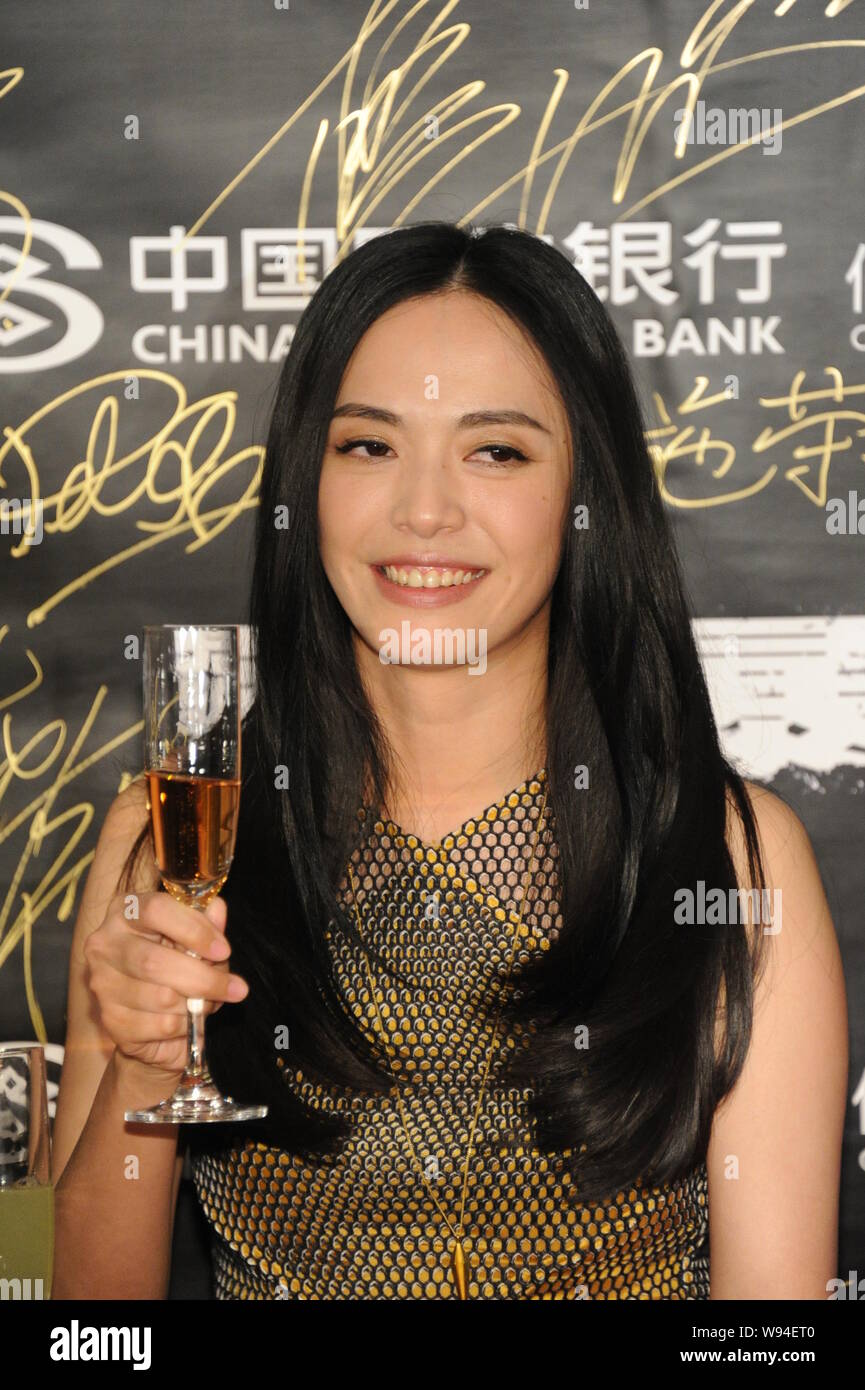 Chinese actress Yao Chen holds champagne on the red carpet for the ...