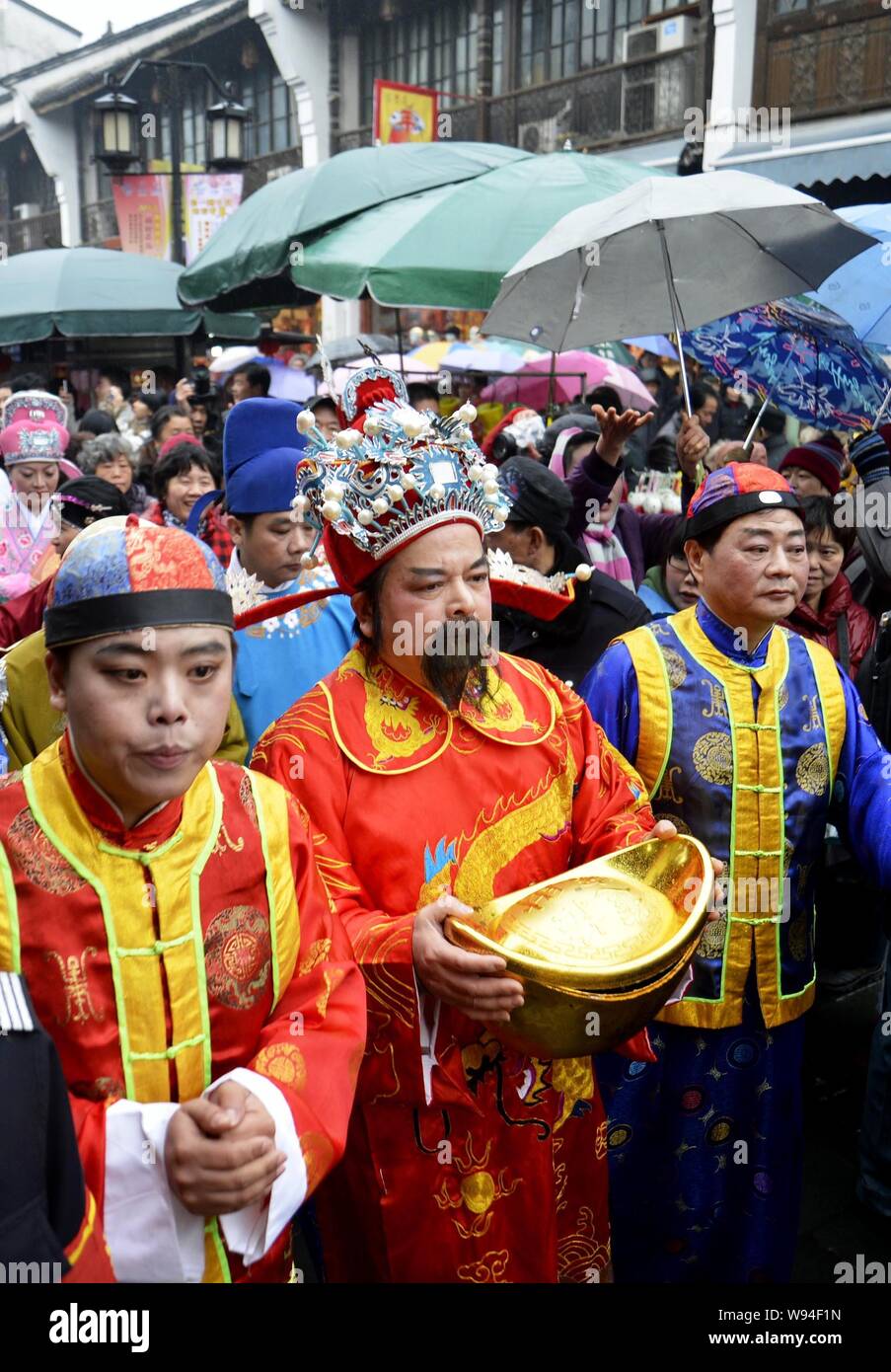 The God of Wealth (front center), acted by a member of staff of the He ...