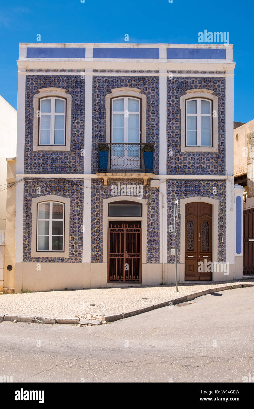 Detached house with exterior wall covered in decorative tiles in the ...