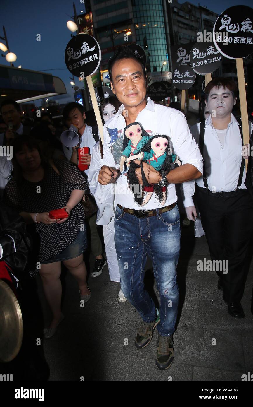 Hong Kong actor Simon Yam, center, poses during the premiere of his new ...