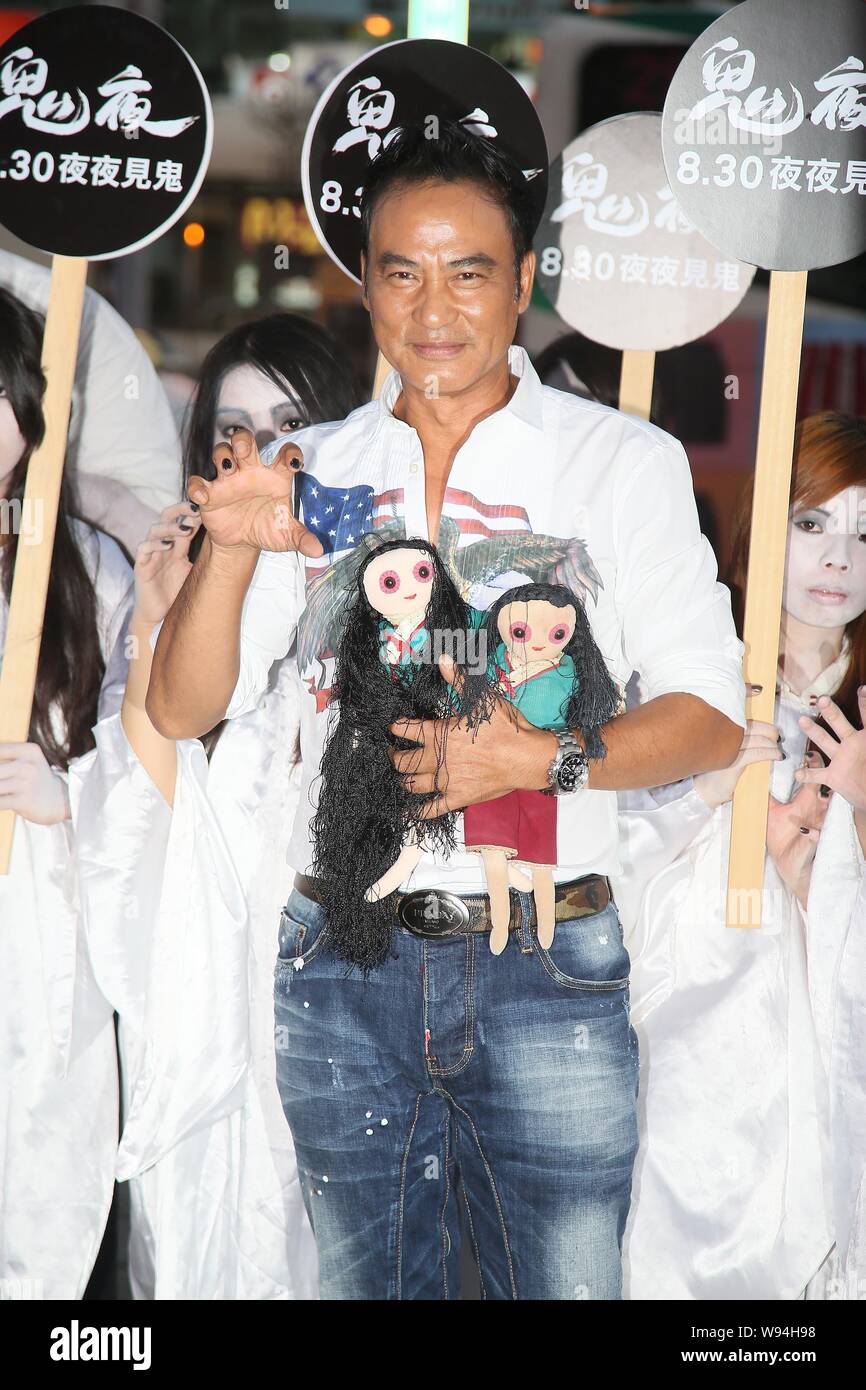 Hong Kong actor Simon Yam, center, poses during the premiere of his new ...