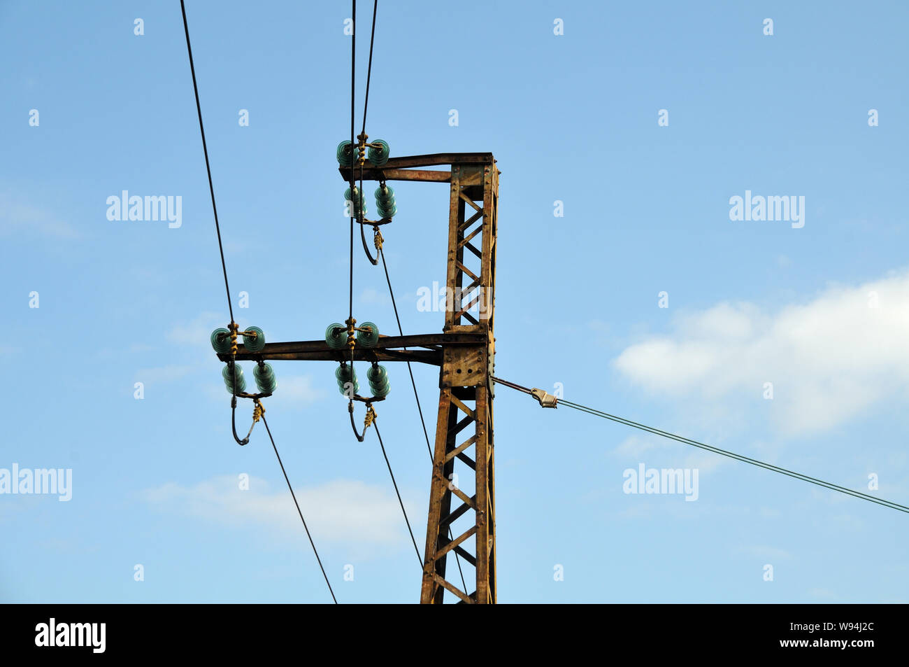 cables and glass disc insulators fixed at rusty metal pylon at a ...
