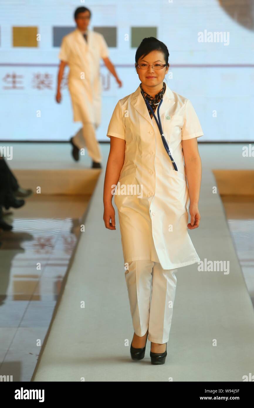 A Chinese doctor displays a new hospital uniform during a fashion show ...
