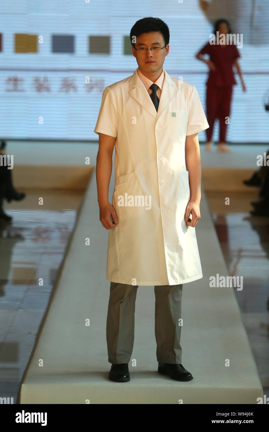 A Chinese doctor displays a new hospital uniform during a fashion show ...