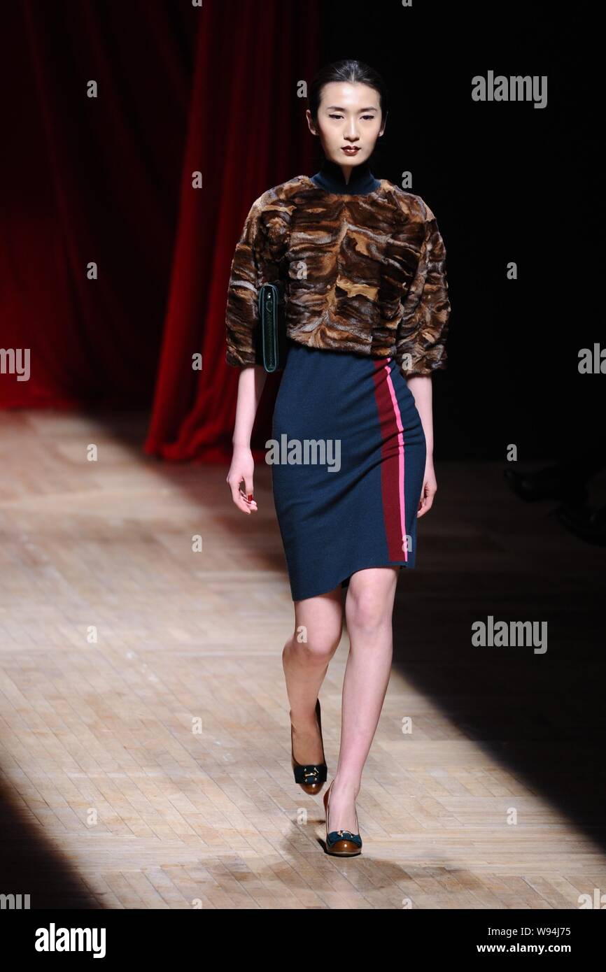A model displays a new creation by Chinese fashion designer Wang Yutao ...