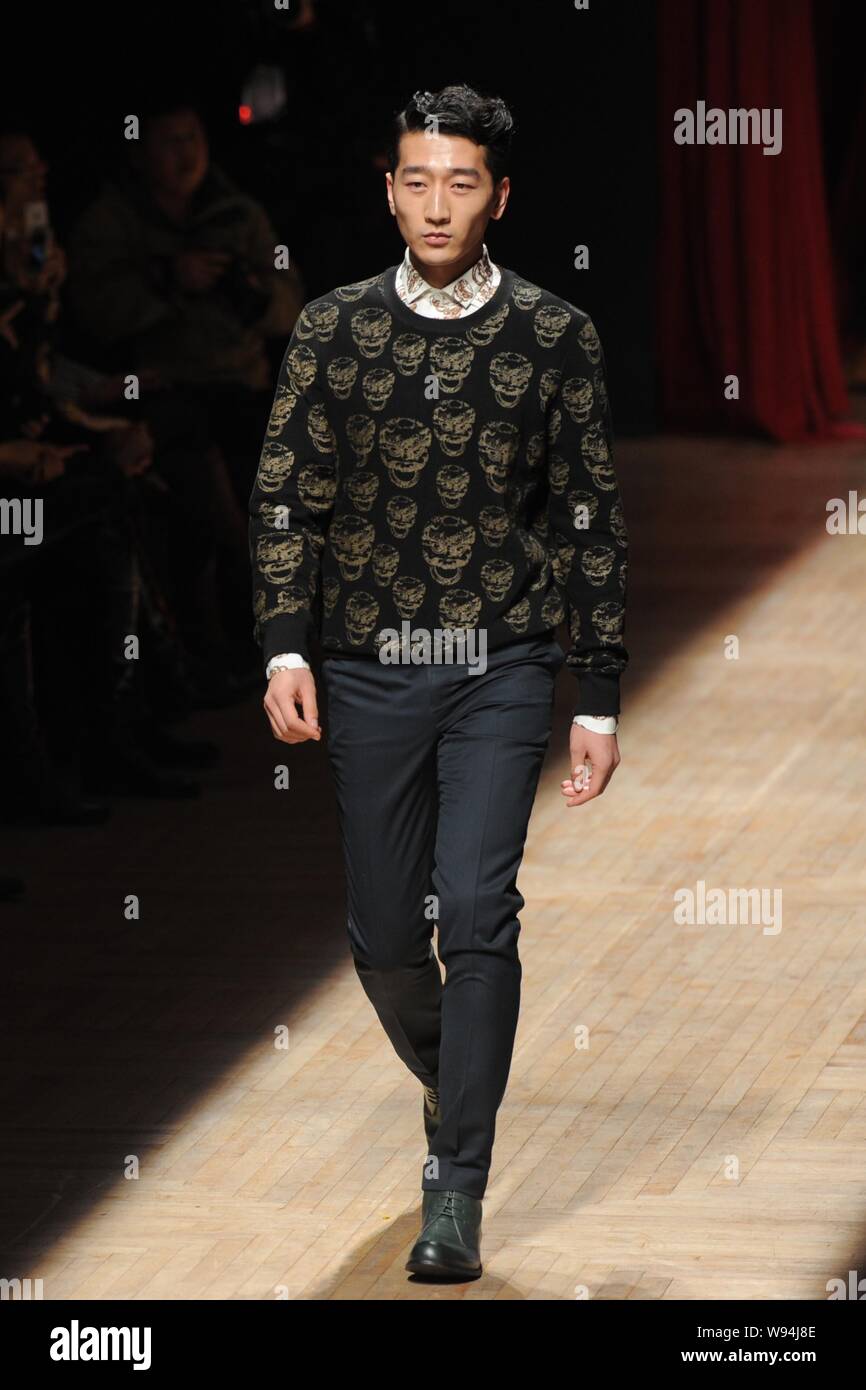 A model displays a new creation by Chinese fashion designer Wang Yutao ...