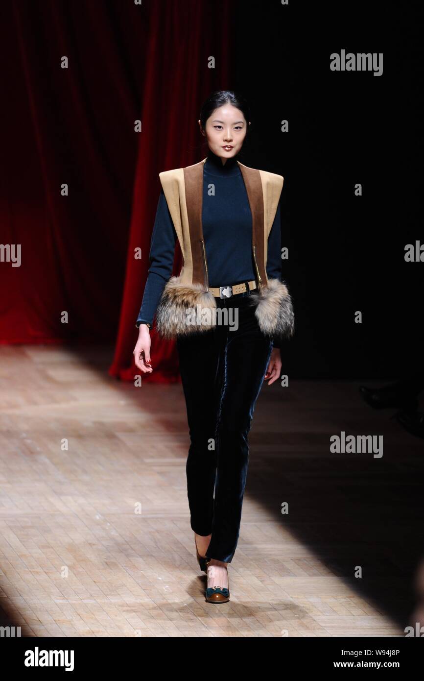 A model displays a new creation by Chinese fashion designer Wang Yutao ...