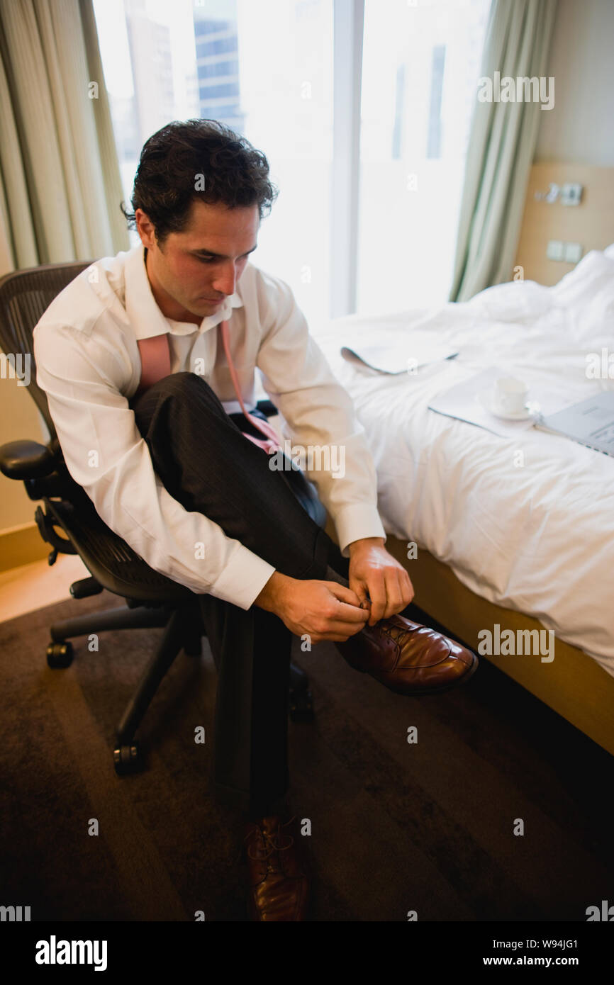 Businessman tying shoe laces hi-res stock photography and images - Alamy