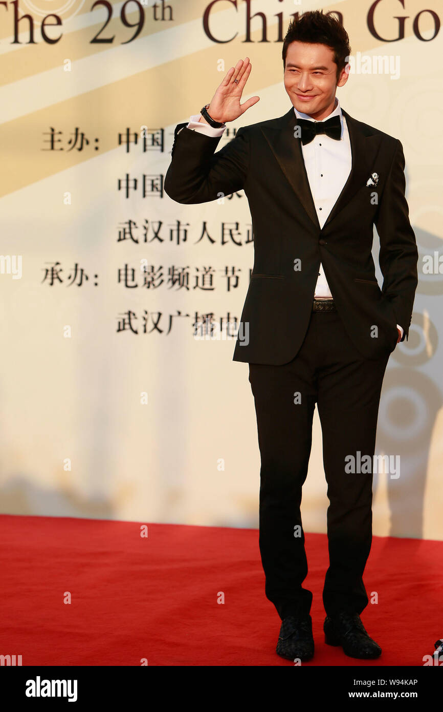 Chinese actor Huang Xiaoming poses as he arrives at the award ceremony ...