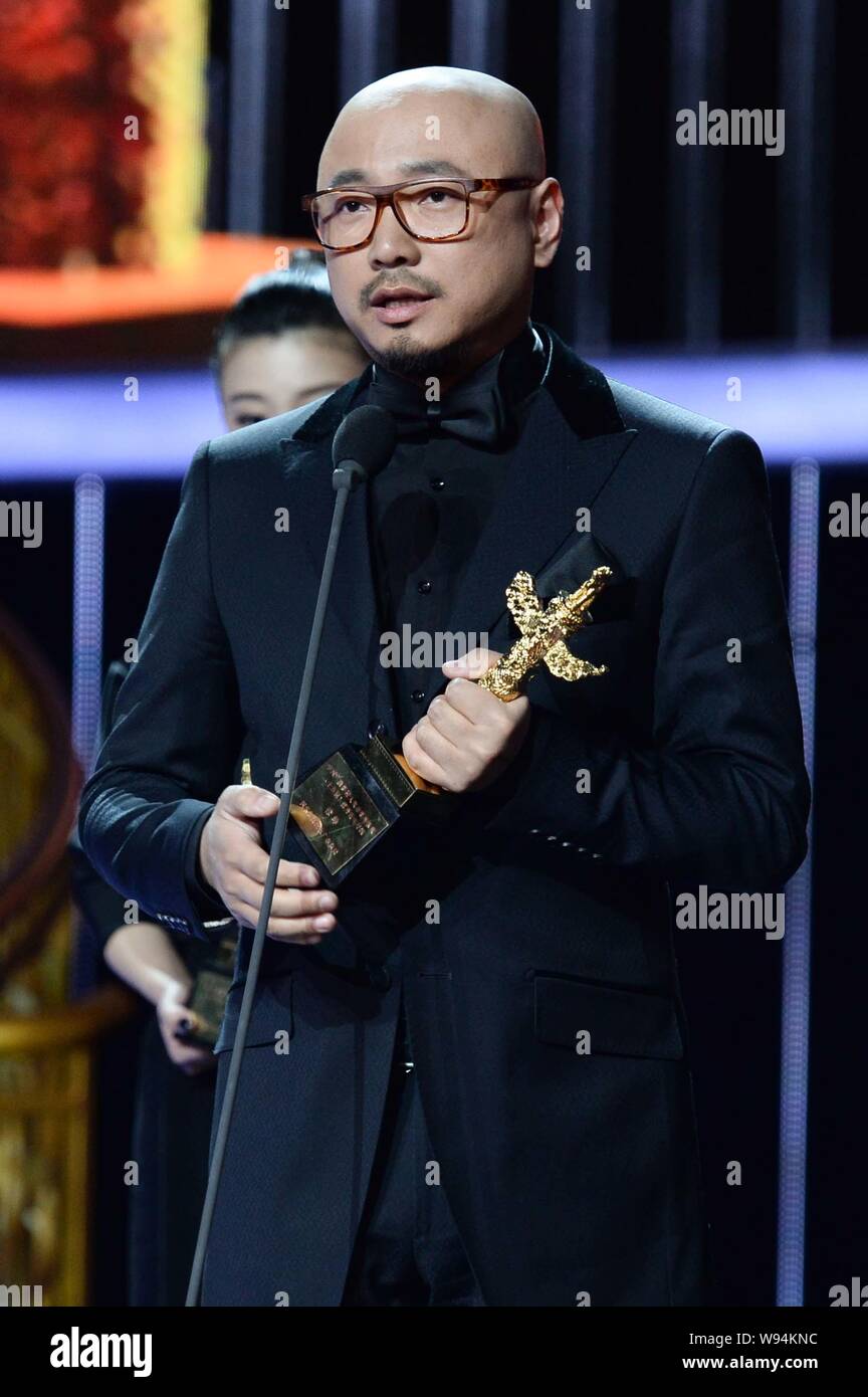 Chinese director and actor Xu Zheng speaks as he holds his trophy for ...