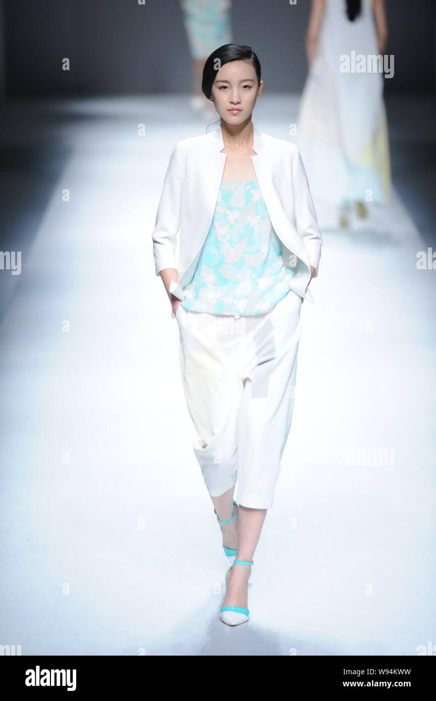 A model displays a new creation at the HLYHLU-Huang Liyong fashion show ...