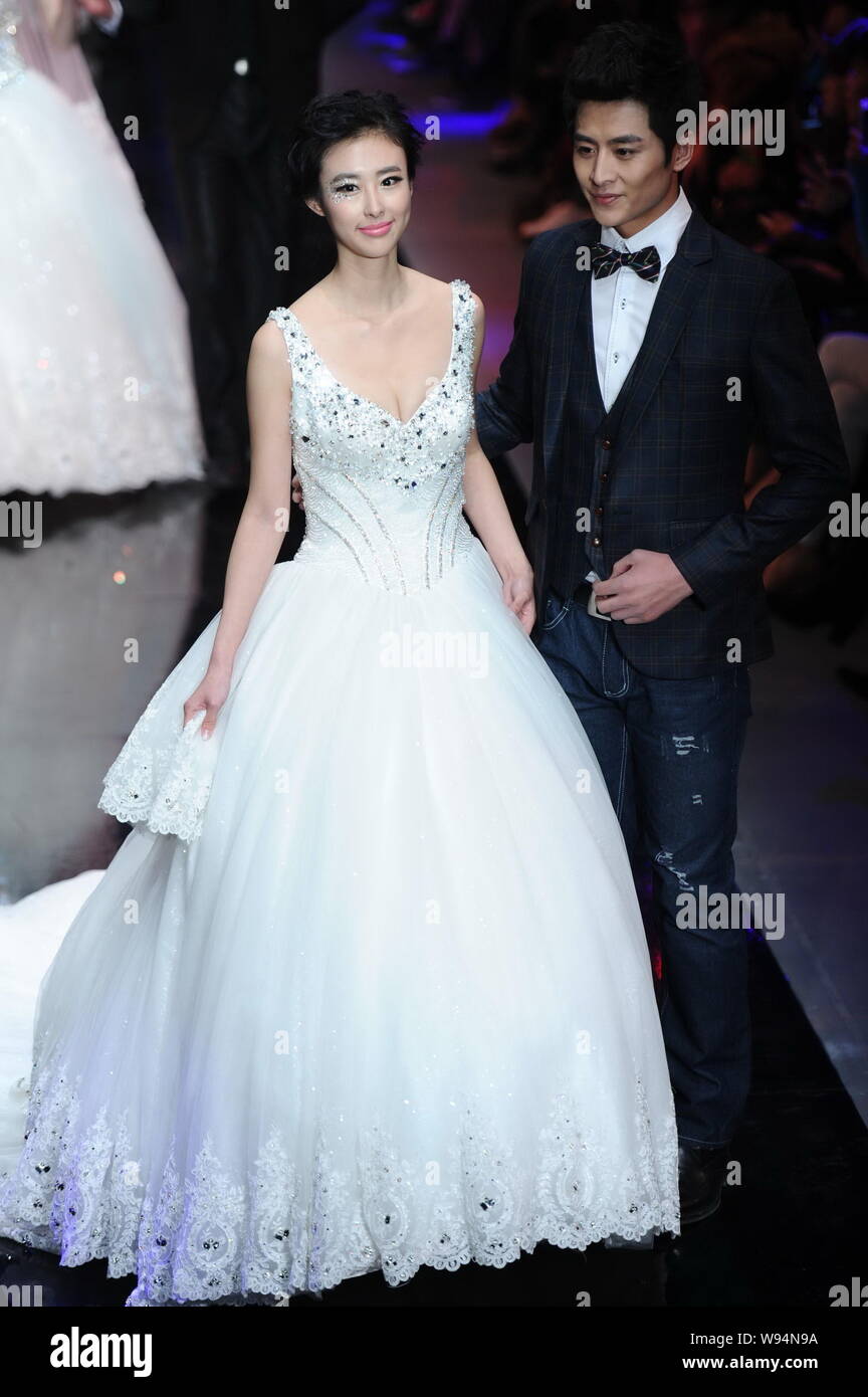 Chinese model Zhai Ling, left, and another model display new creations by Chinese fashion ...