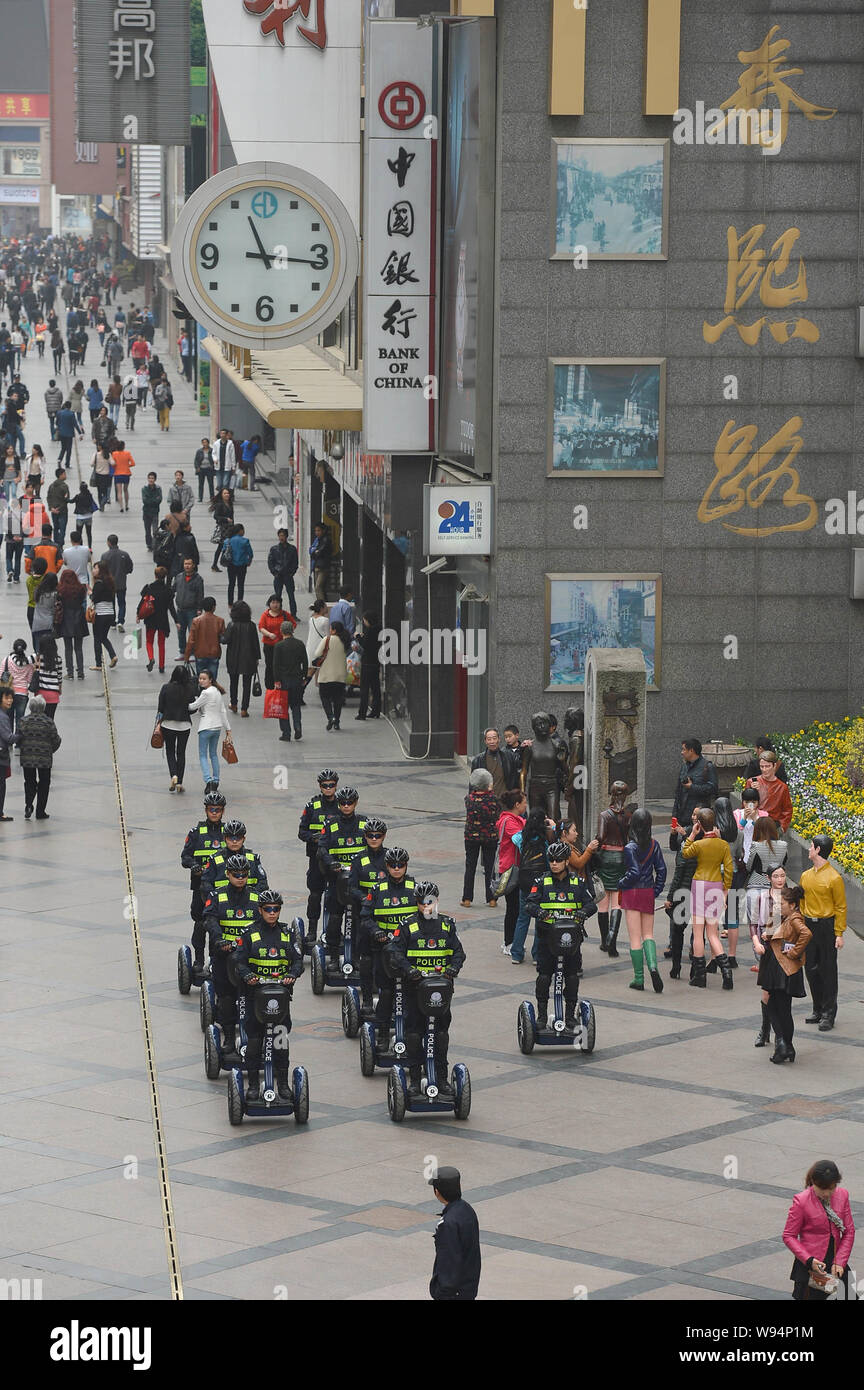 Chinese police officers ride Segway-like two-wheeled electric vehicles ...