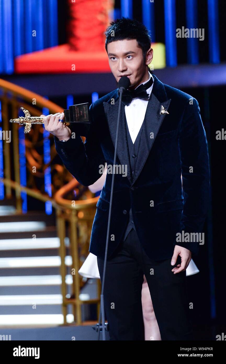 Chinese actor Huang Xiaoming speaks as he holds his trophy for the Best ...