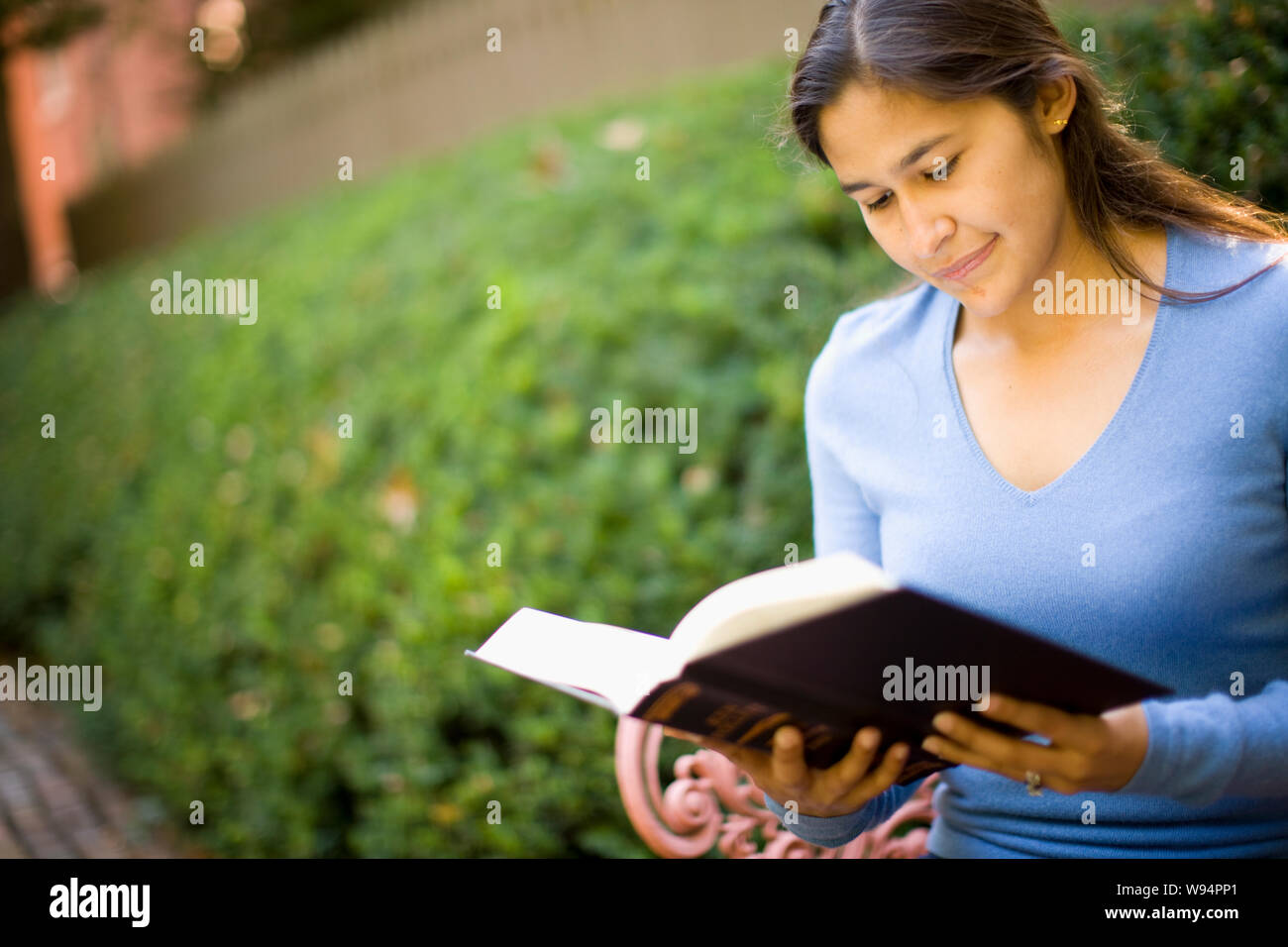 Girl reading a book outside Stock Photo - Alamy
