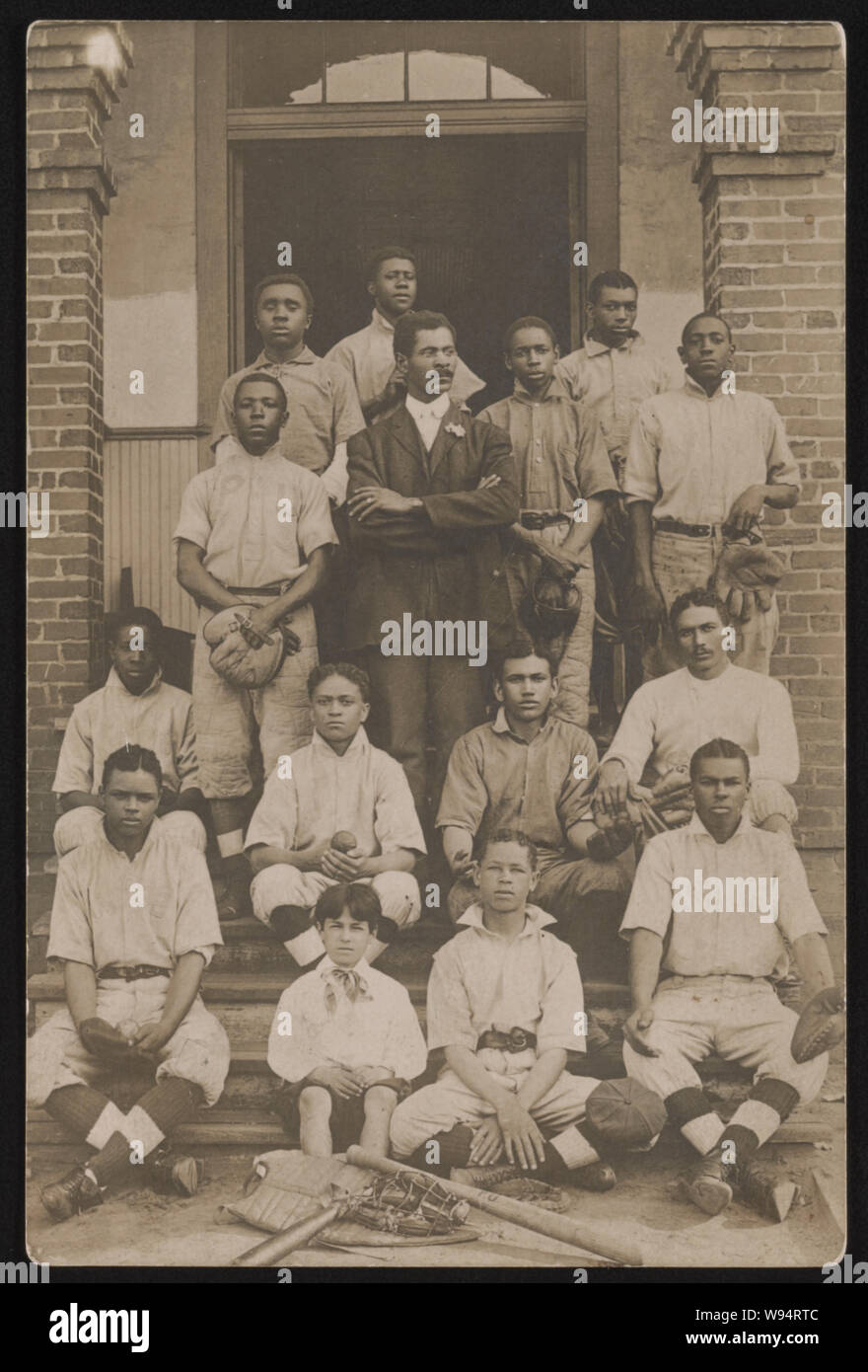 African American baseball team posing on front steps of building Stock ...
