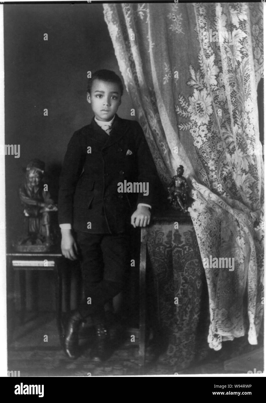 African American boy, full-length portrait, standing, facing front with ...