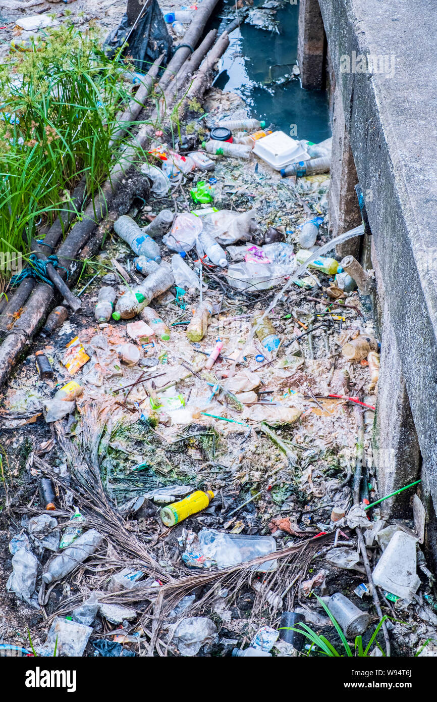 Ecology watercourse river canal with garbage and plastic inside city ...