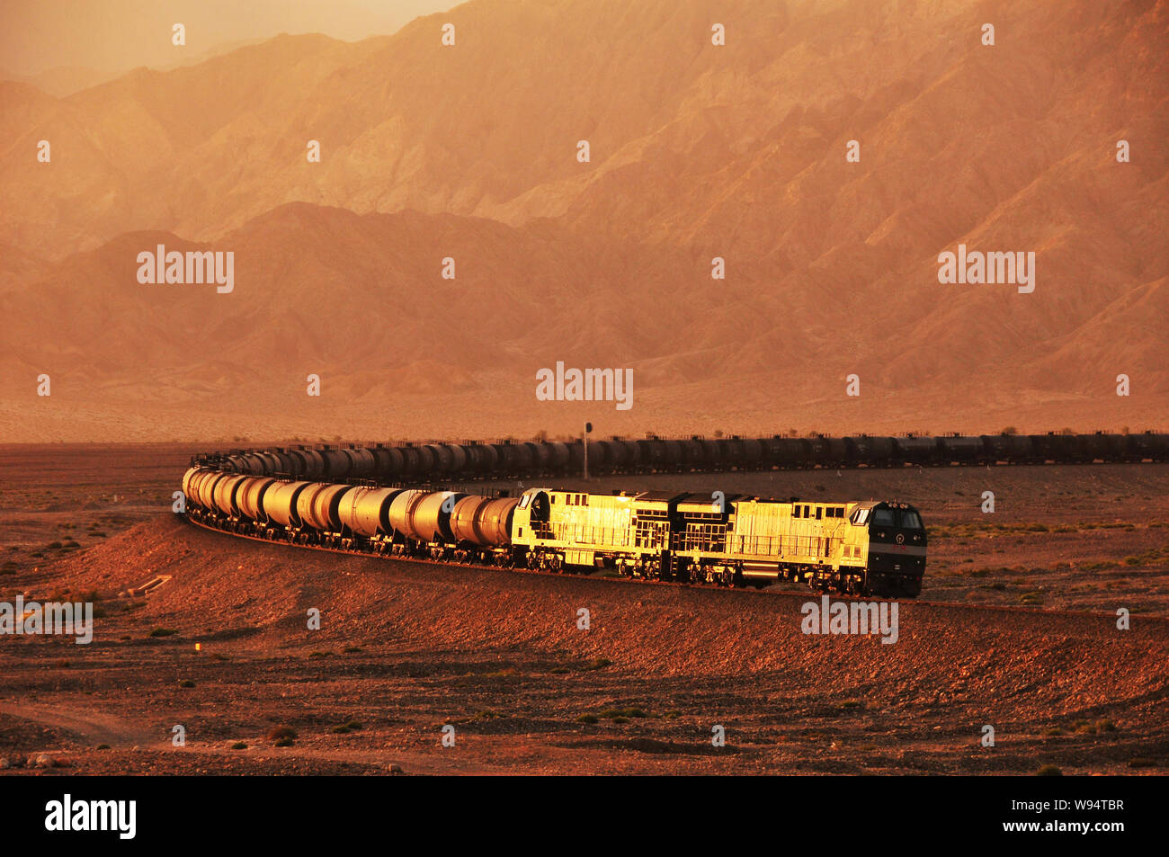 A freight train with liquid cargo passes through the desert in Hejing ...