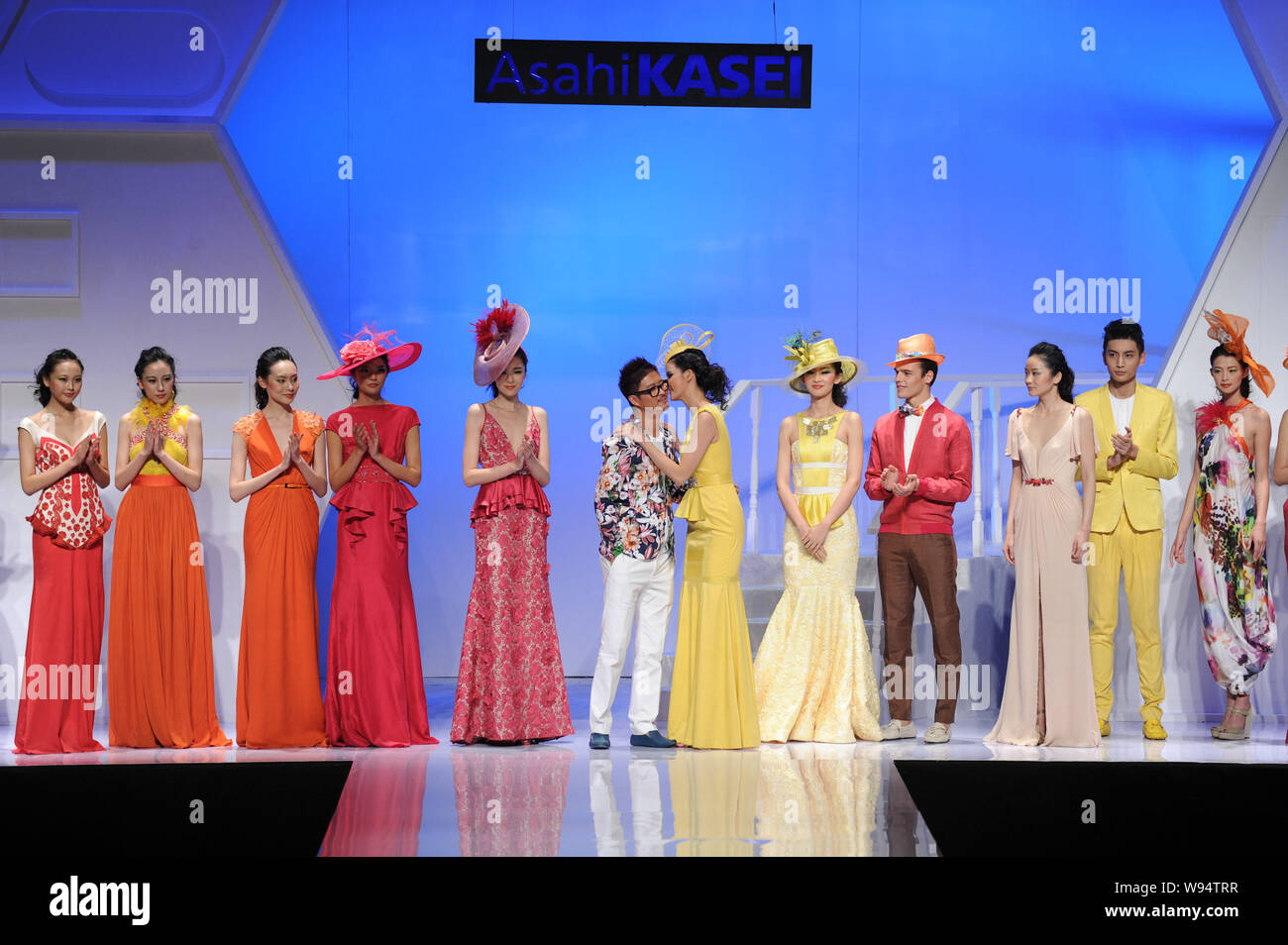 Chinese model Mo Wandan, 6th right, kisses Hong Kong designer Dorian Ho ...