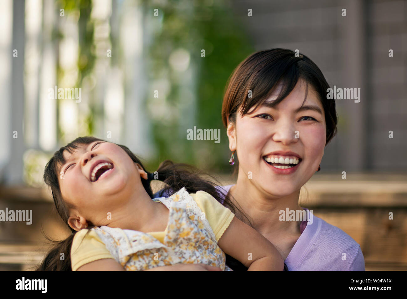 Mother and daughter laughing together Stock Photo - Alamy