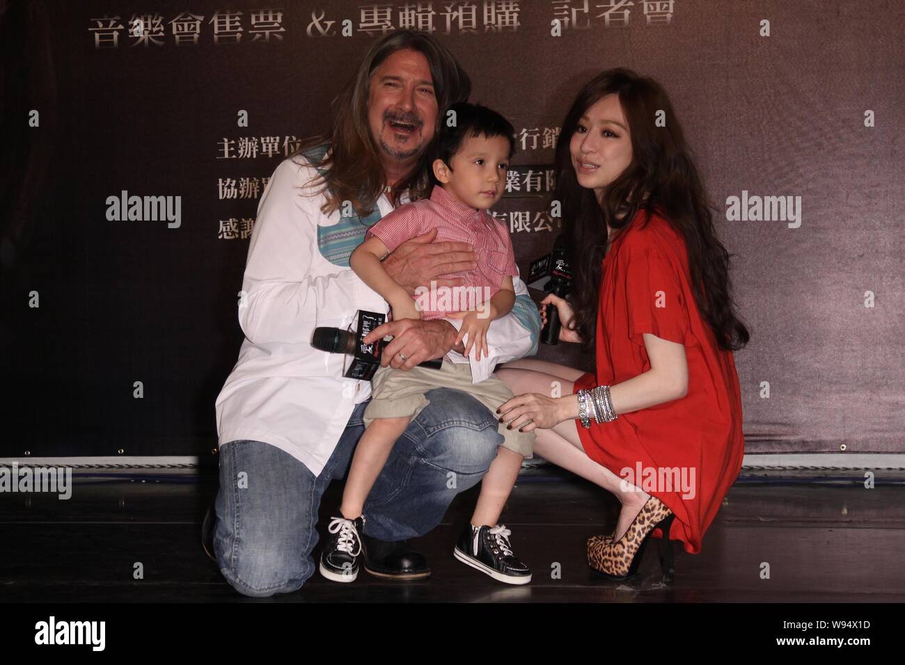 Canadian recording artist Matthew Lien, left, holds his son and poses ...