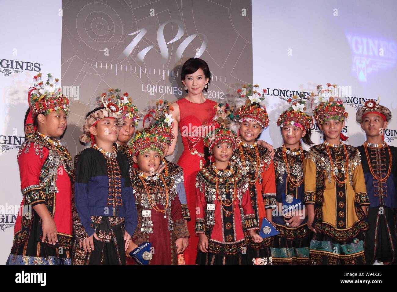 Taiwanese model and actress Lin Chi-ling, back, poses with young ethnic ...