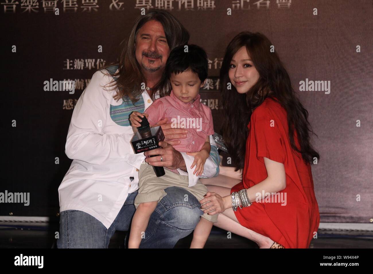 Canadian recording artist Matthew Lien, left, holds his son and poses with Taiwanese singer and ...