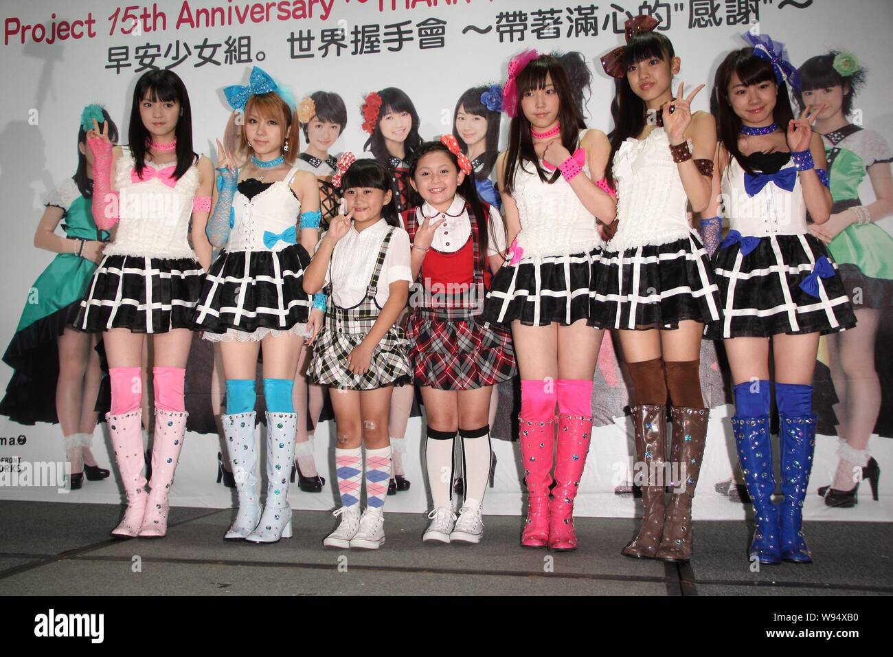 Members of Japanese pop idol girl group Morning Musume pose with two ...