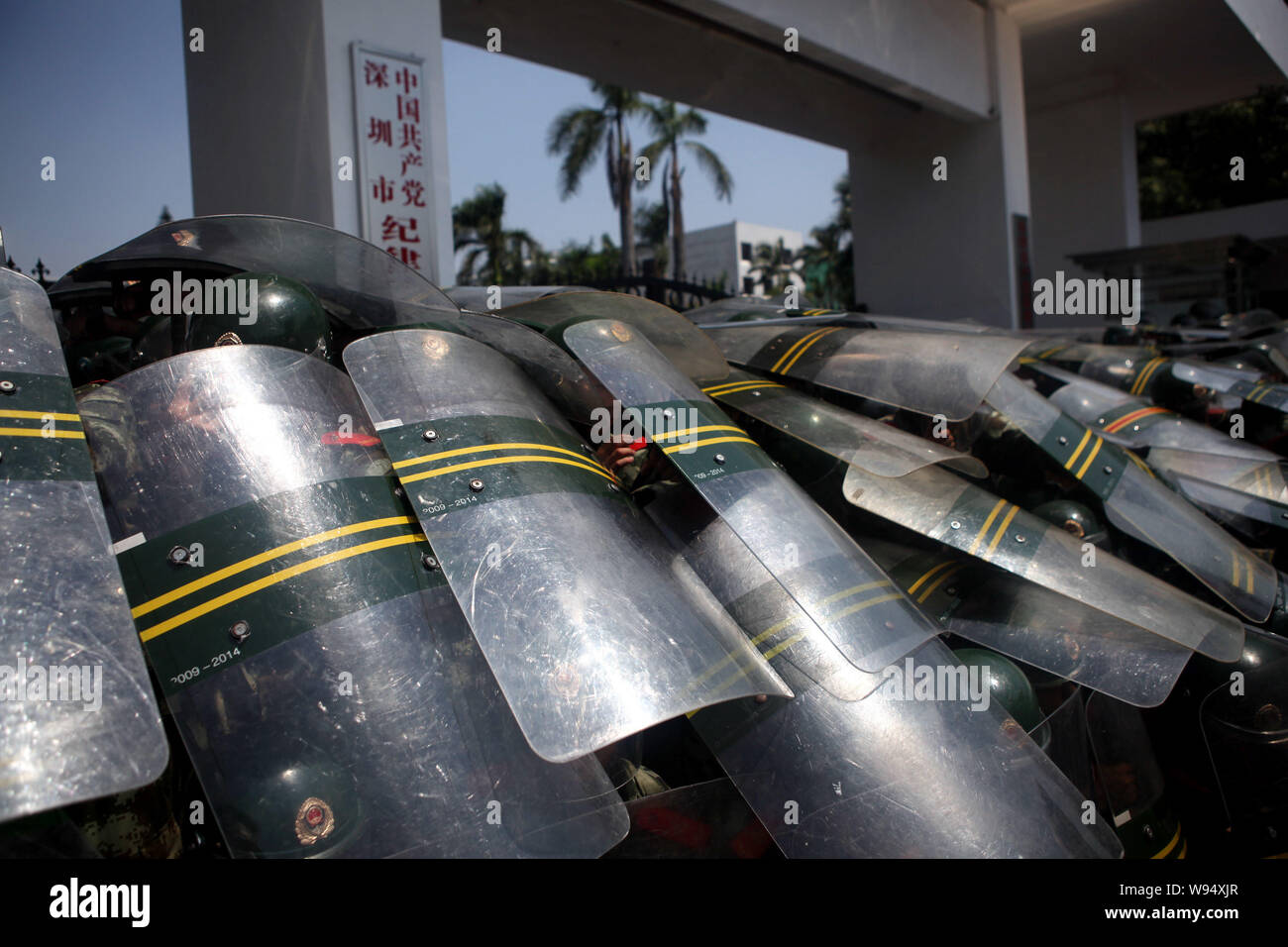 Riot policemen stand behind shields during an anti-Japan protest parade ...