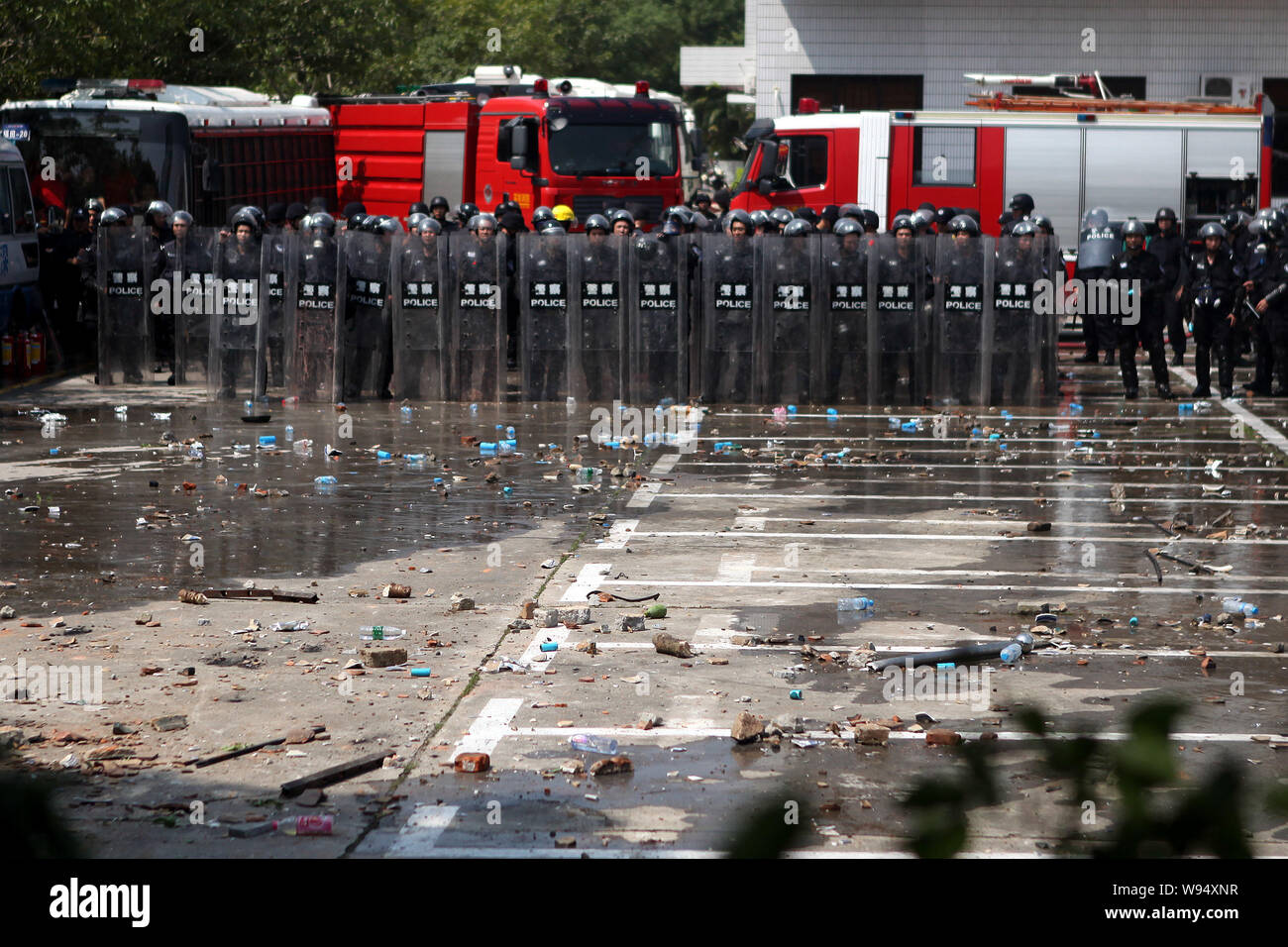 Riot policemen stand behind shields during an anti-Japan protest parade ...