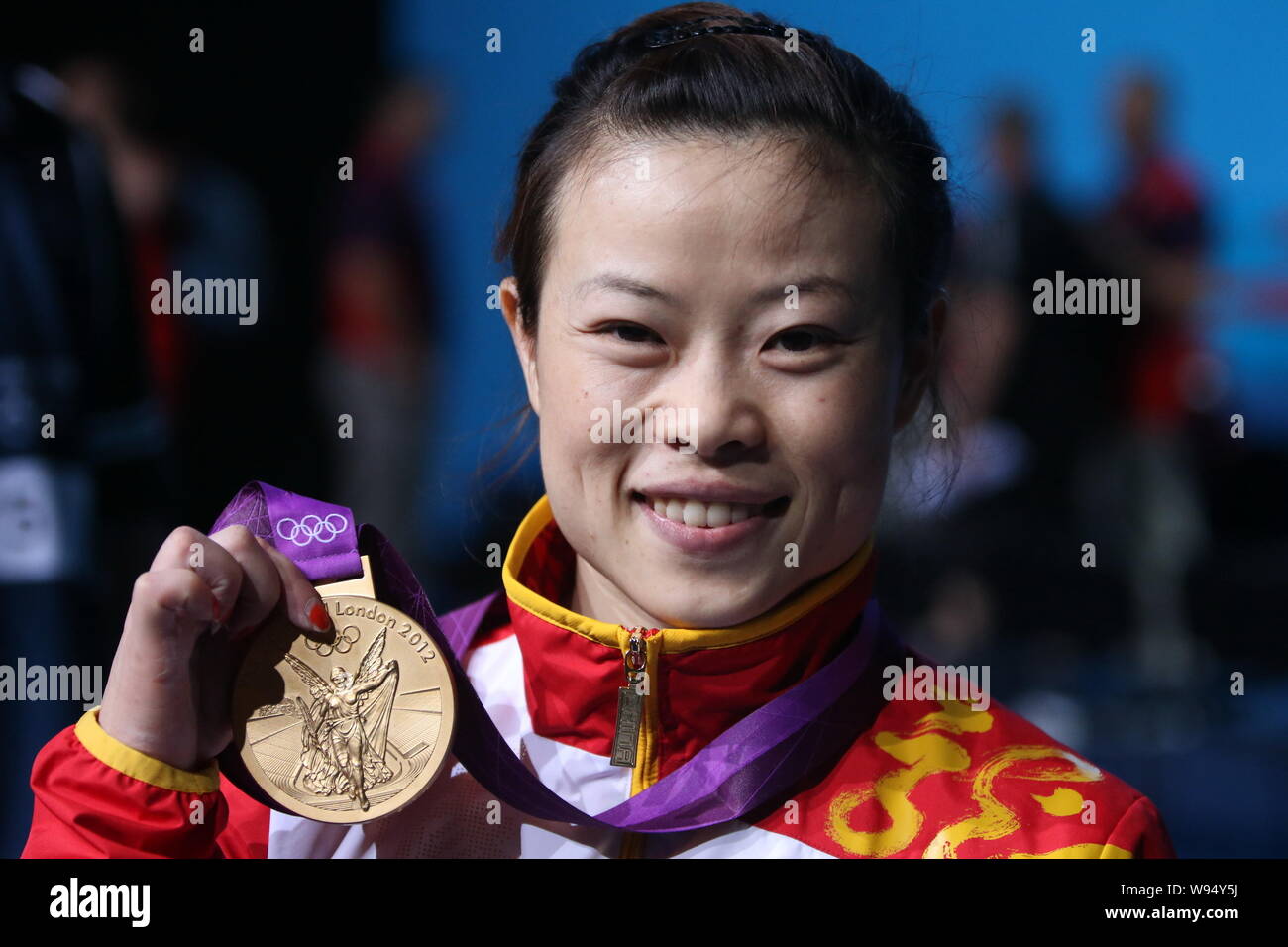 Gold medalist Wang Mingjuan of China shows her medal at the award ...