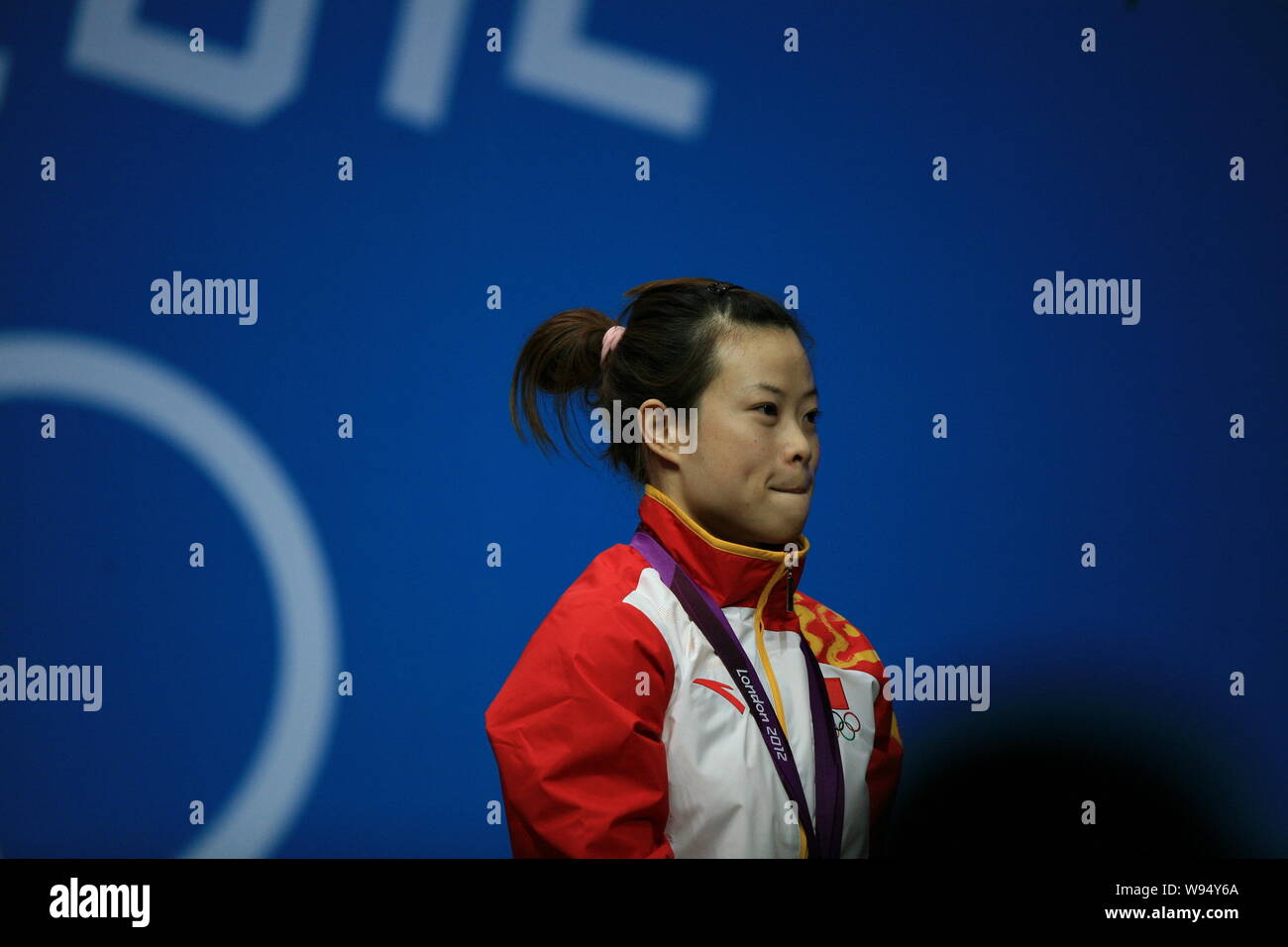 Gold medalist Wang Mingjuan of China poses at the award ceremony after ...