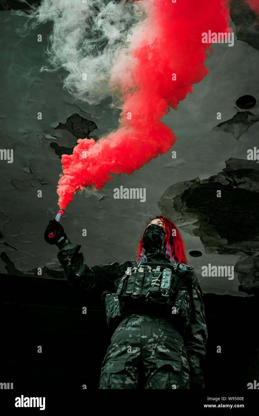 Red-hair woman in military uniform with alarm smoke fire in hand Stock ...