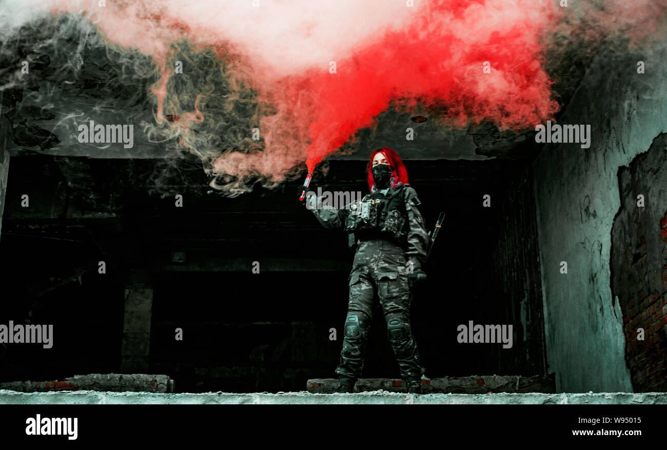 Red-hair woman in military uniform with alarm smoke fire in hand Stock ...