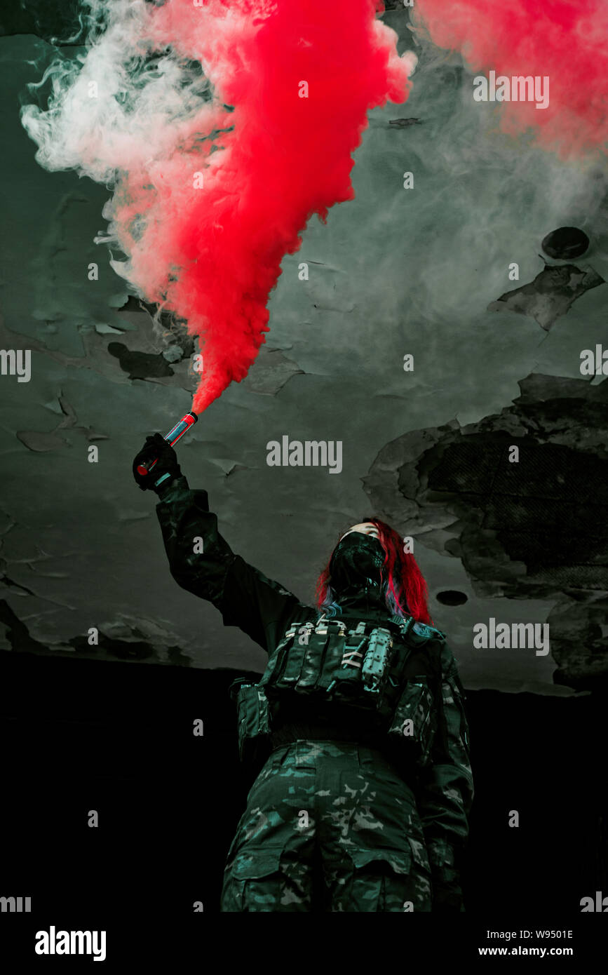 Red-hair woman in military uniform with alarm smoke fire in hand Stock ...