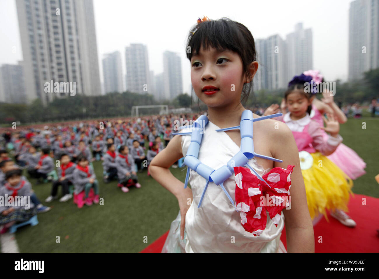 Young Chinese students pose to show new creations made with recycled ...