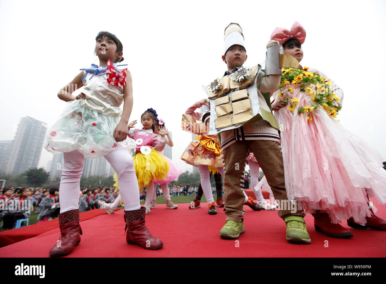 Young Chinese students pose to show new creations made with recycled ...