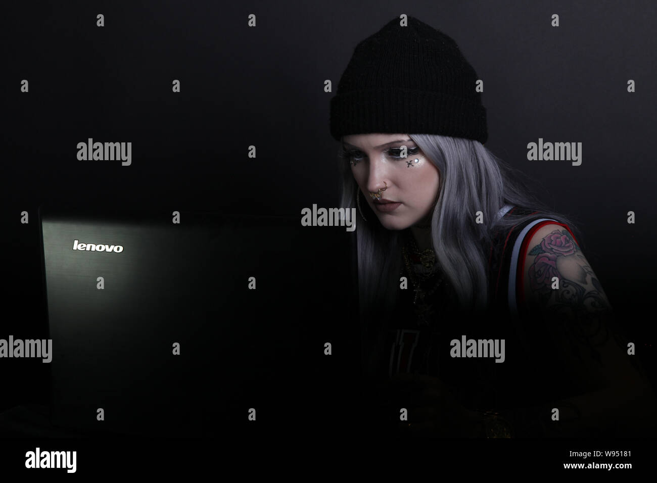 Young female millennial on Lenovo G780 laptop, modern day hacker, low ...