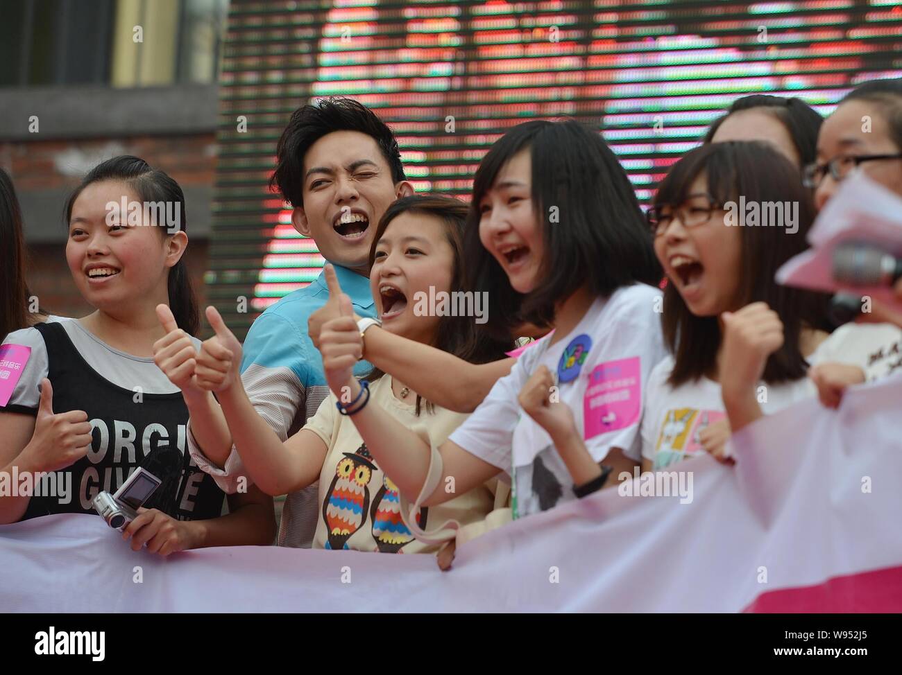 Taiwanese singer Yoga Lin, second left, poses with fans during the fan ...