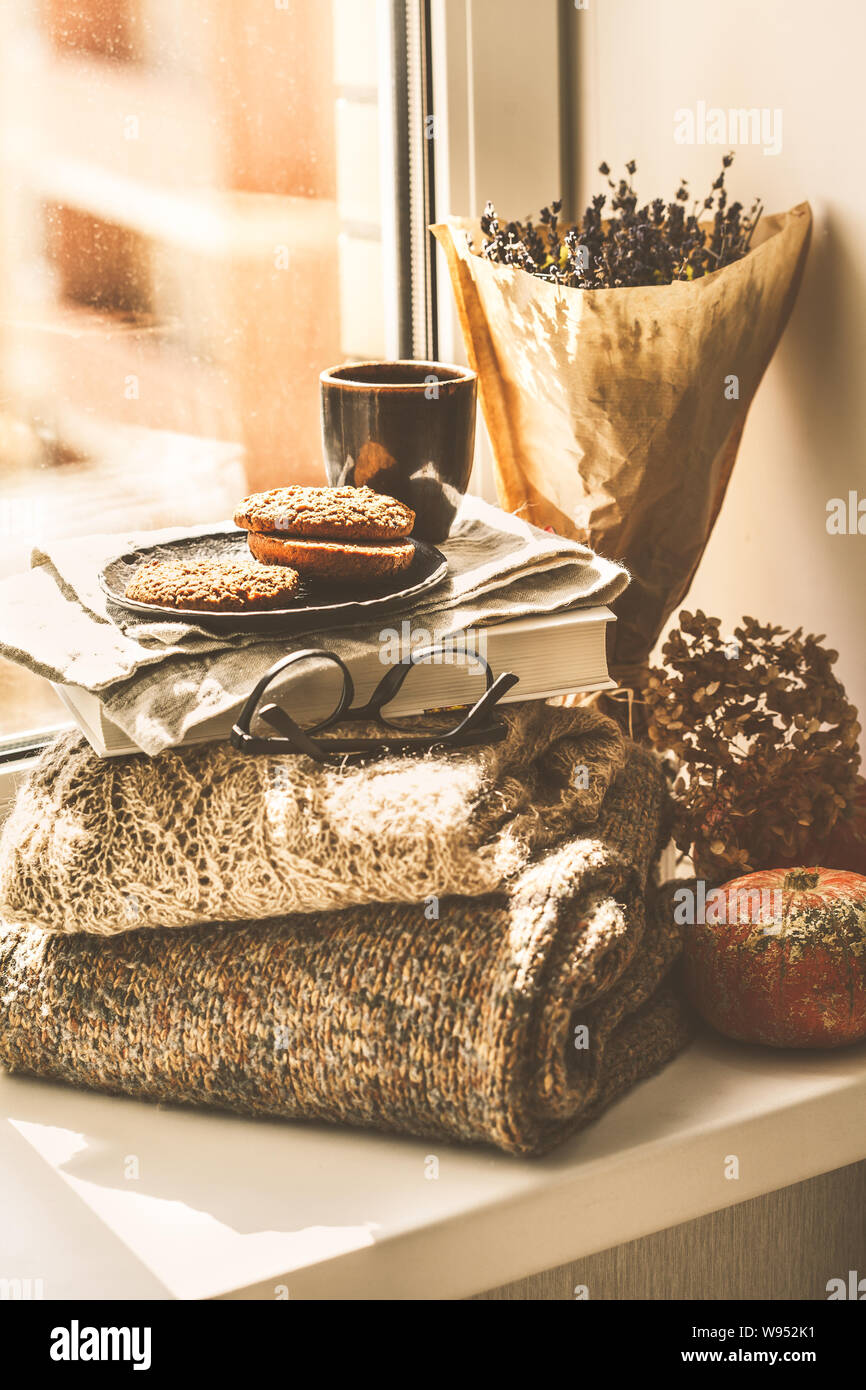 Autumn window sill background with books, tea and cookies Stock Photo ...