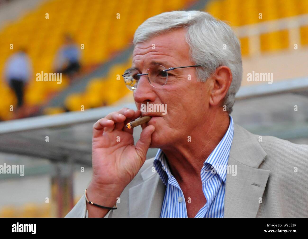 Head coach Marcello Lippi of Chinas Guangzhou Evergrande FC smokes ...