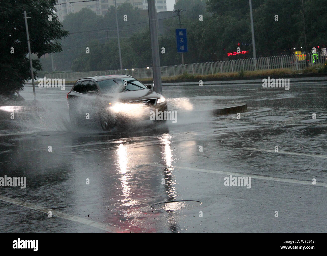 A car is pictured in the heavy rainfall in Beijing, China, 21 July 2012 ...
