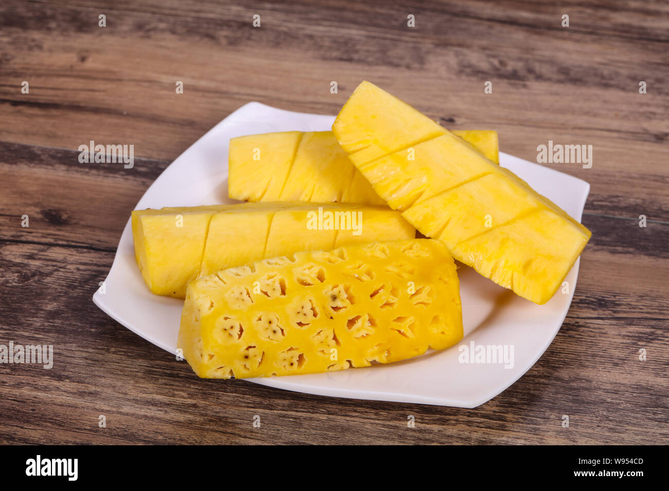 Sliced sweet ripe tasty pineapple in the plate Stock Photo - Alamy