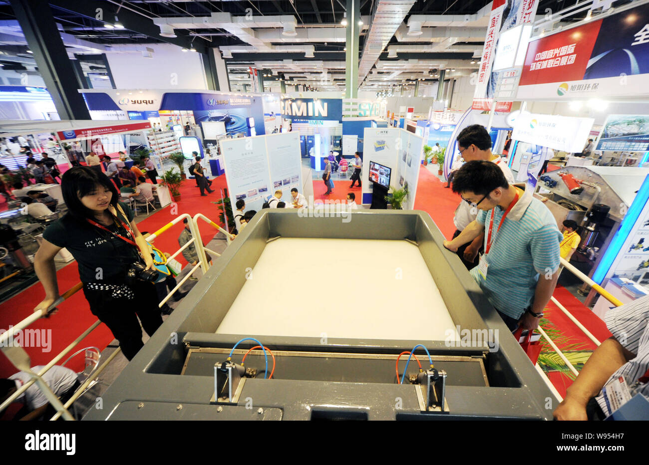 Visitors look at a model floataion tank for water purifying during the ...