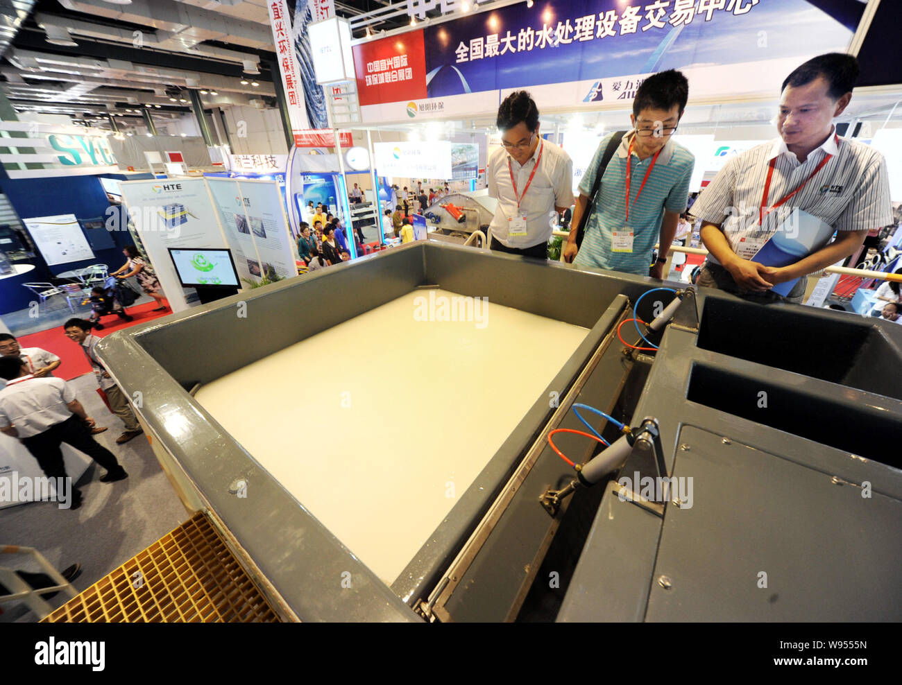 Visitors look at a model floataion tank for water purifying during the ...