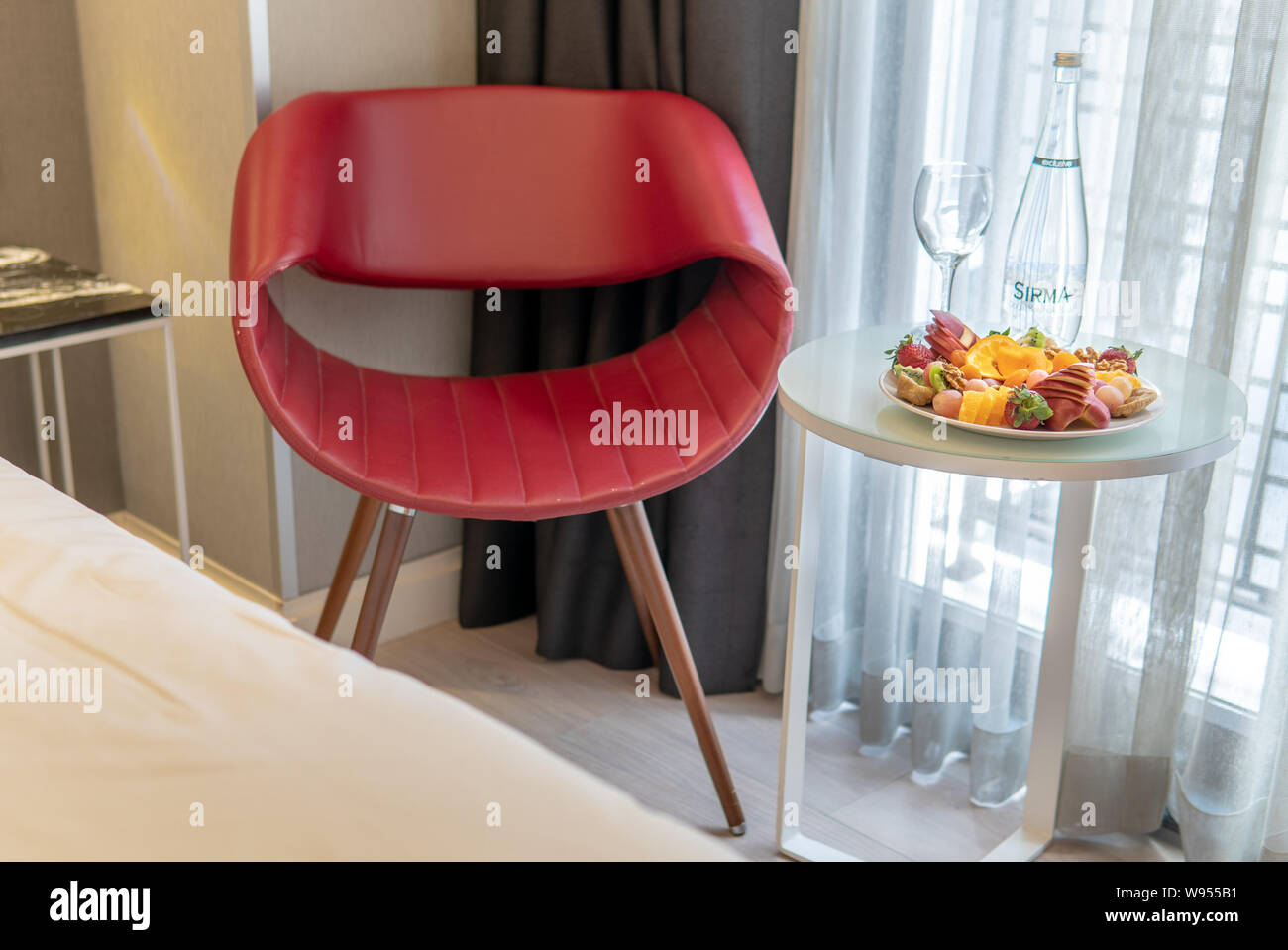 Fruit platter in hotel room with red chair in background Stock Photo ...