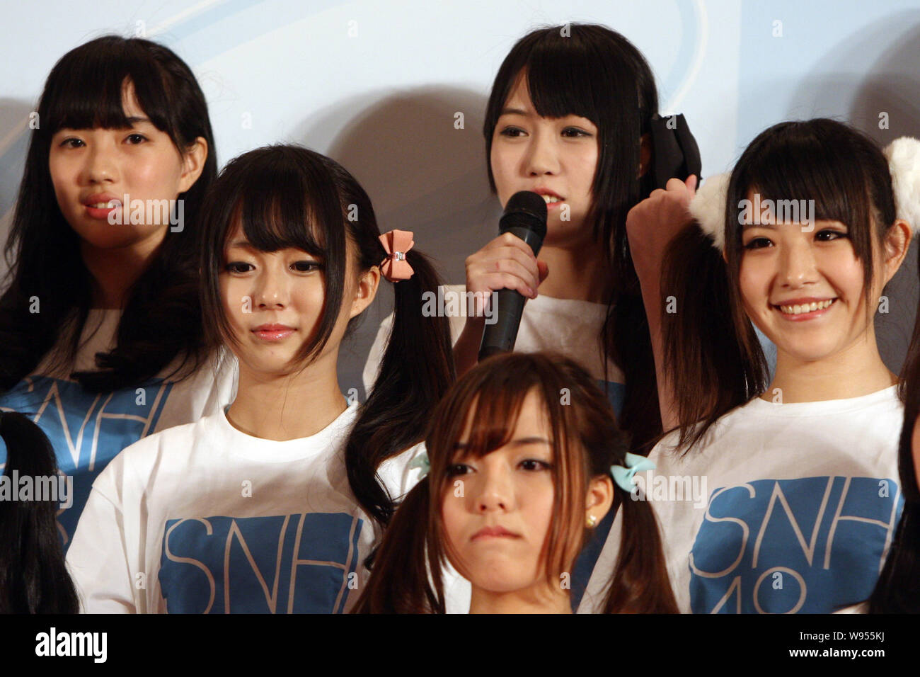 Young girls of Chinese pop group SNH48 attend a ceremony in Shanghai ...